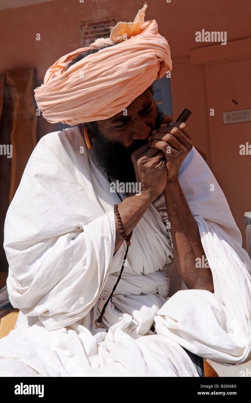 A sadhu smokes from his chillum Stock Photo - Alamy