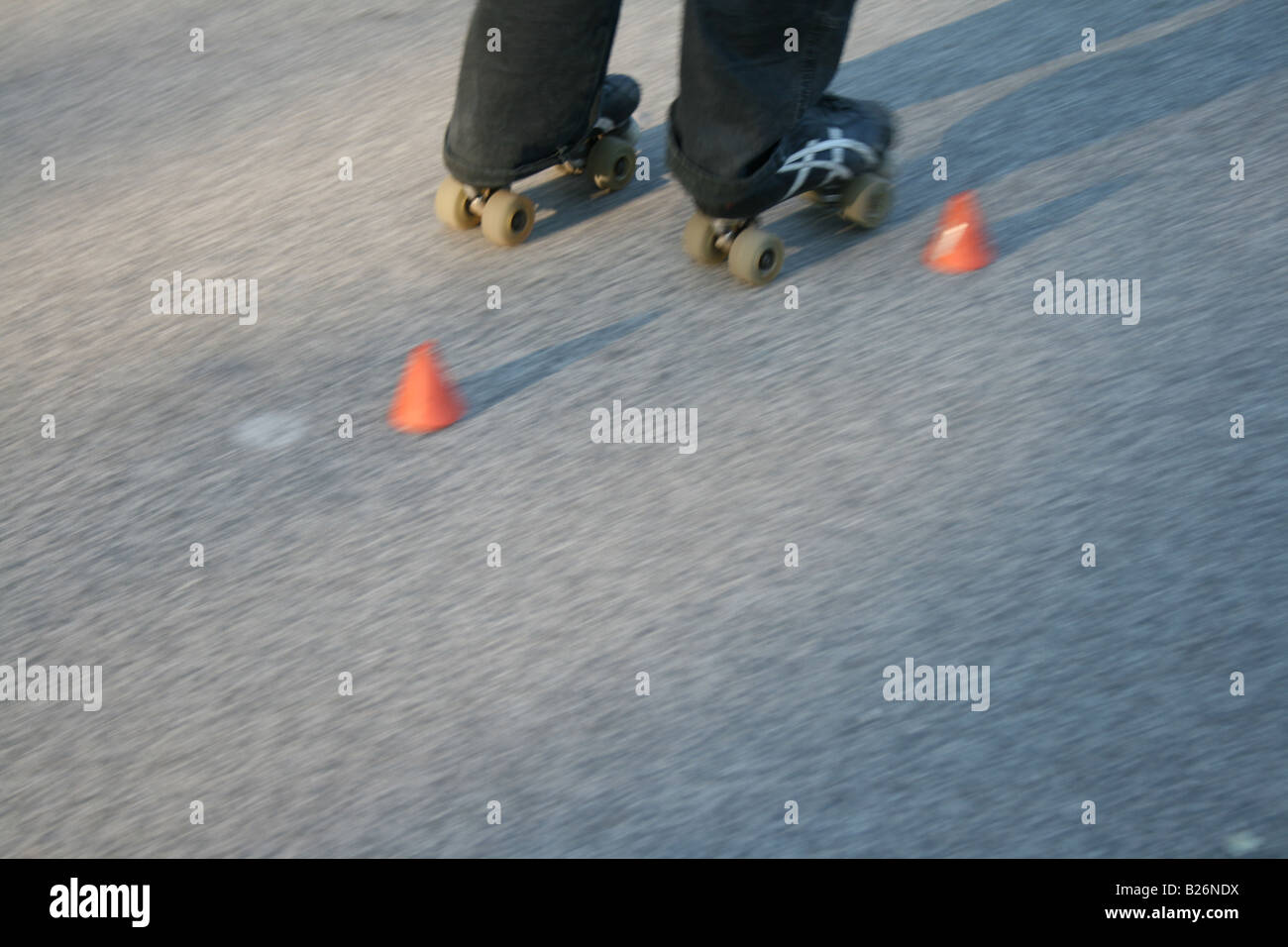 fast rollerskater doing obstacle course cones in street in park Stock ...