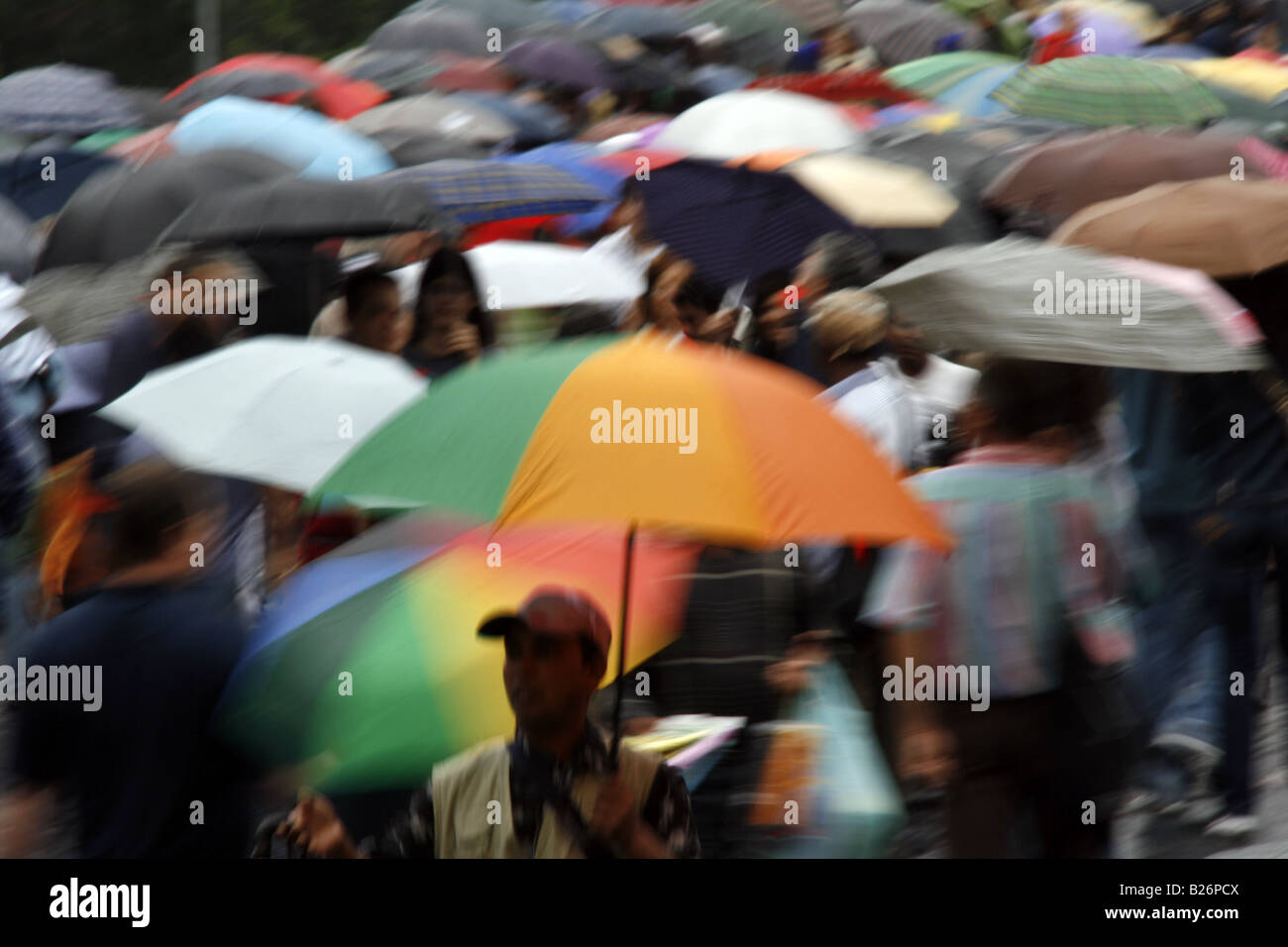 crowd of people with umbrellas in rain in town Stock Photo - Alamy