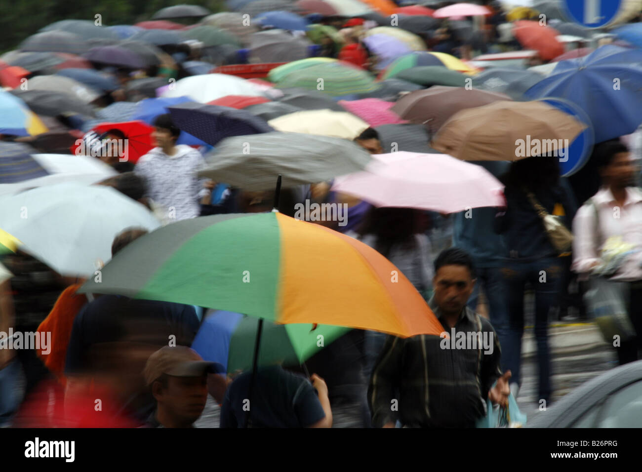 crowd of people with umbrellas in rain in town Stock Photo - Alamy