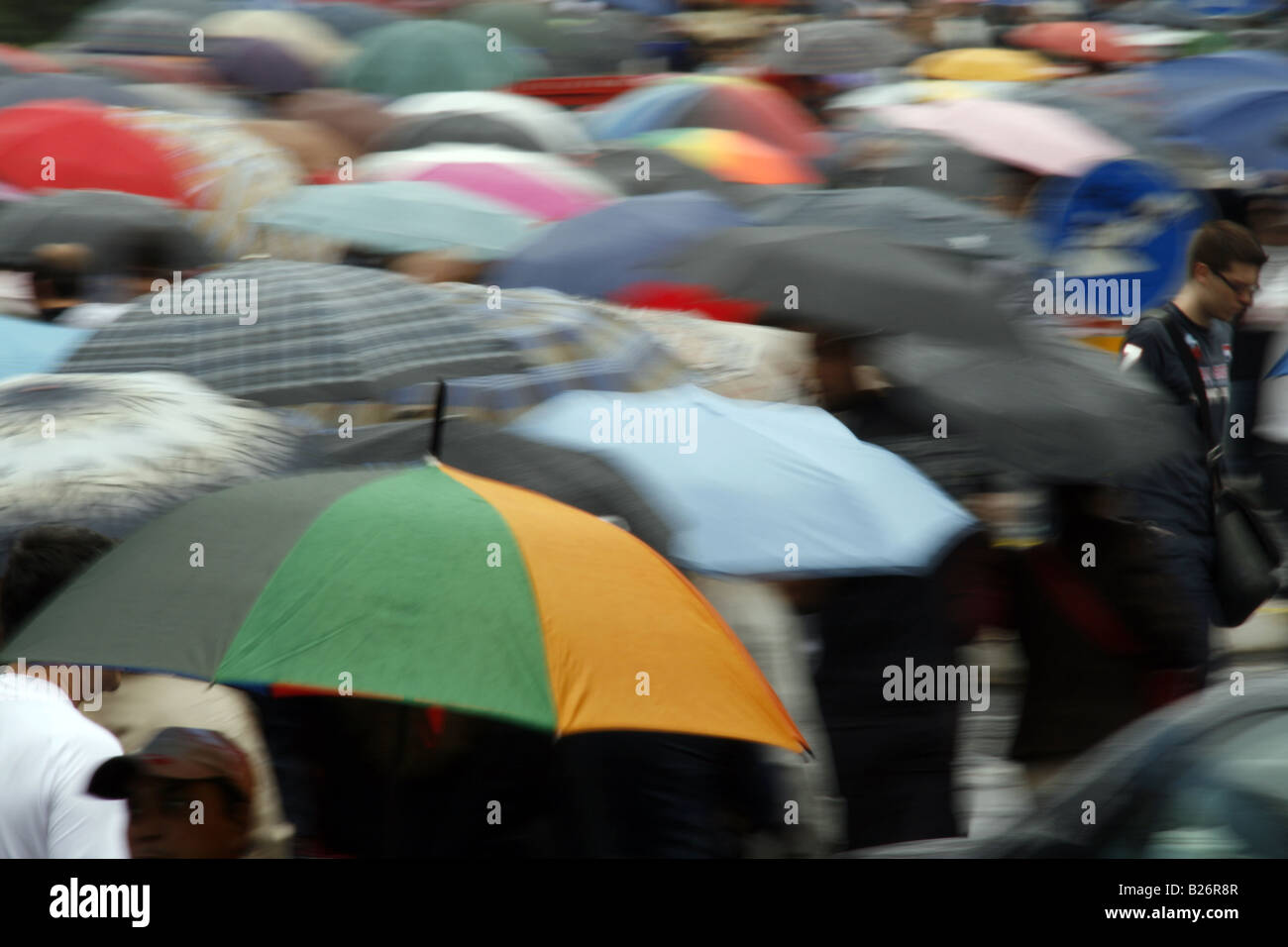 crowd of people with umbrellas in rain in town Stock Photo - Alamy