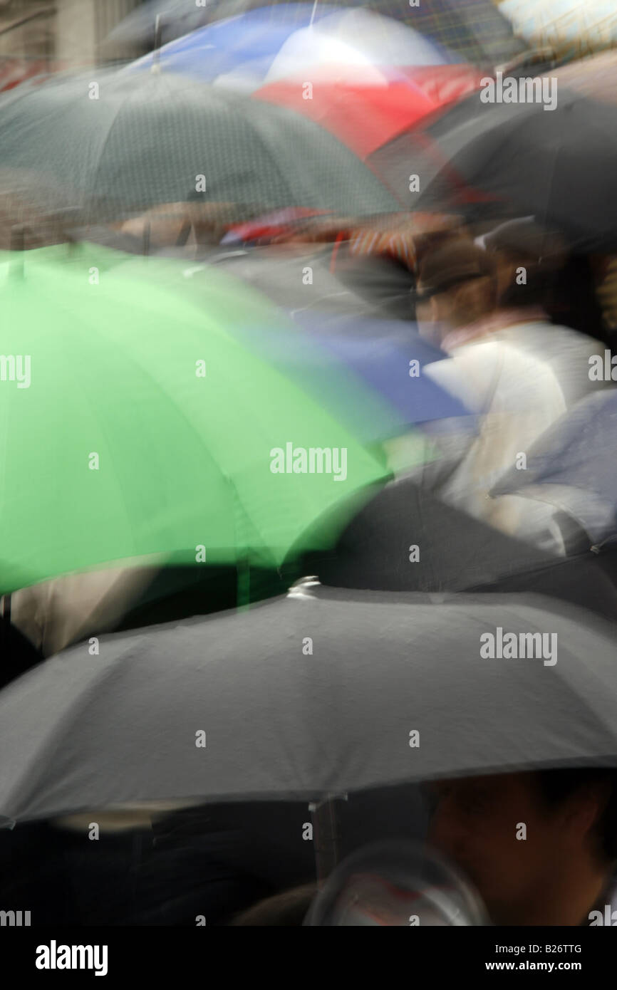 crowd of people with umbrellas in rain in town Stock Photo - Alamy