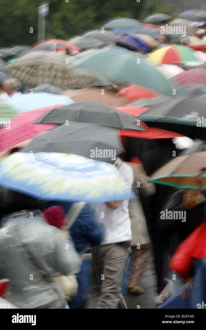 crowd of people with umbrellas in rain in town Stock Photo - Alamy