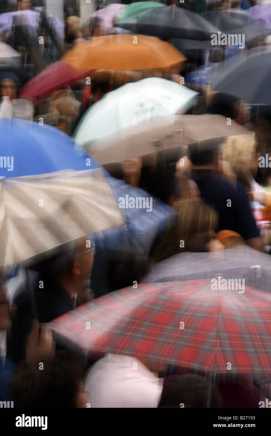 crowd of people with umbrellas in rain in town Stock Photo - Alamy
