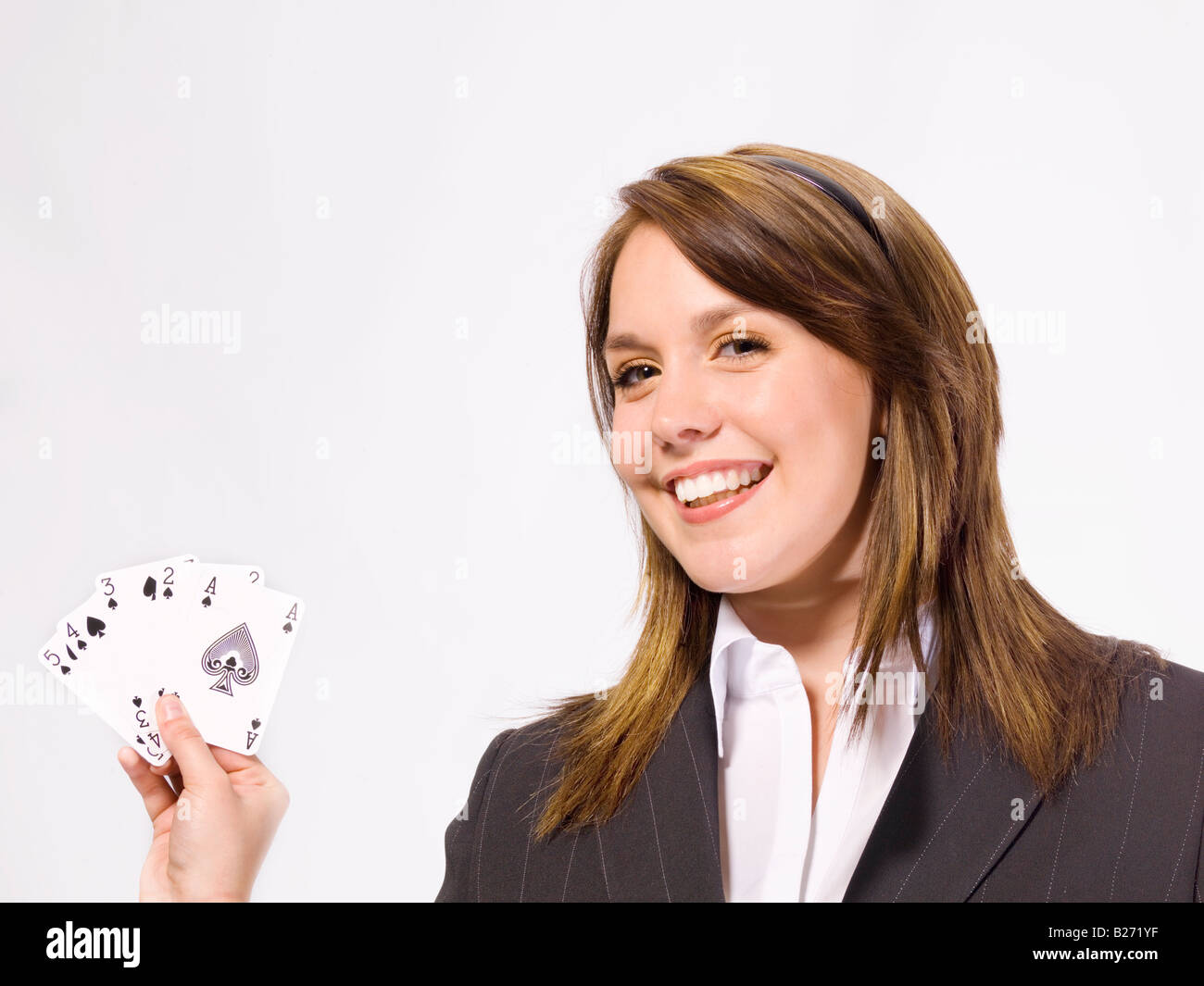 Woman smiling with flush of playing cards Stock Photo - Alamy