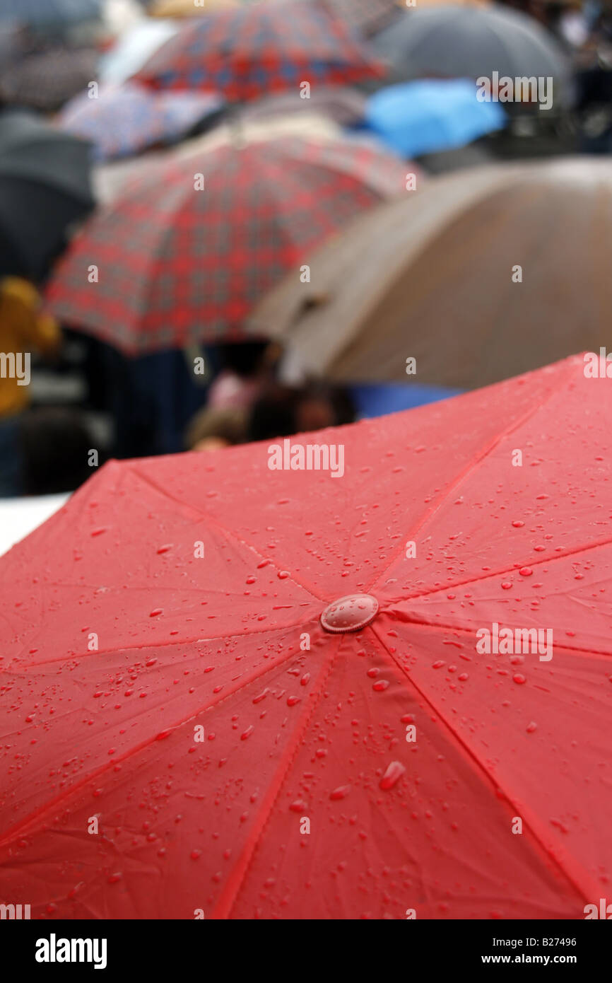 crowd of people with umbrellas in rain in town Stock Photo - Alamy