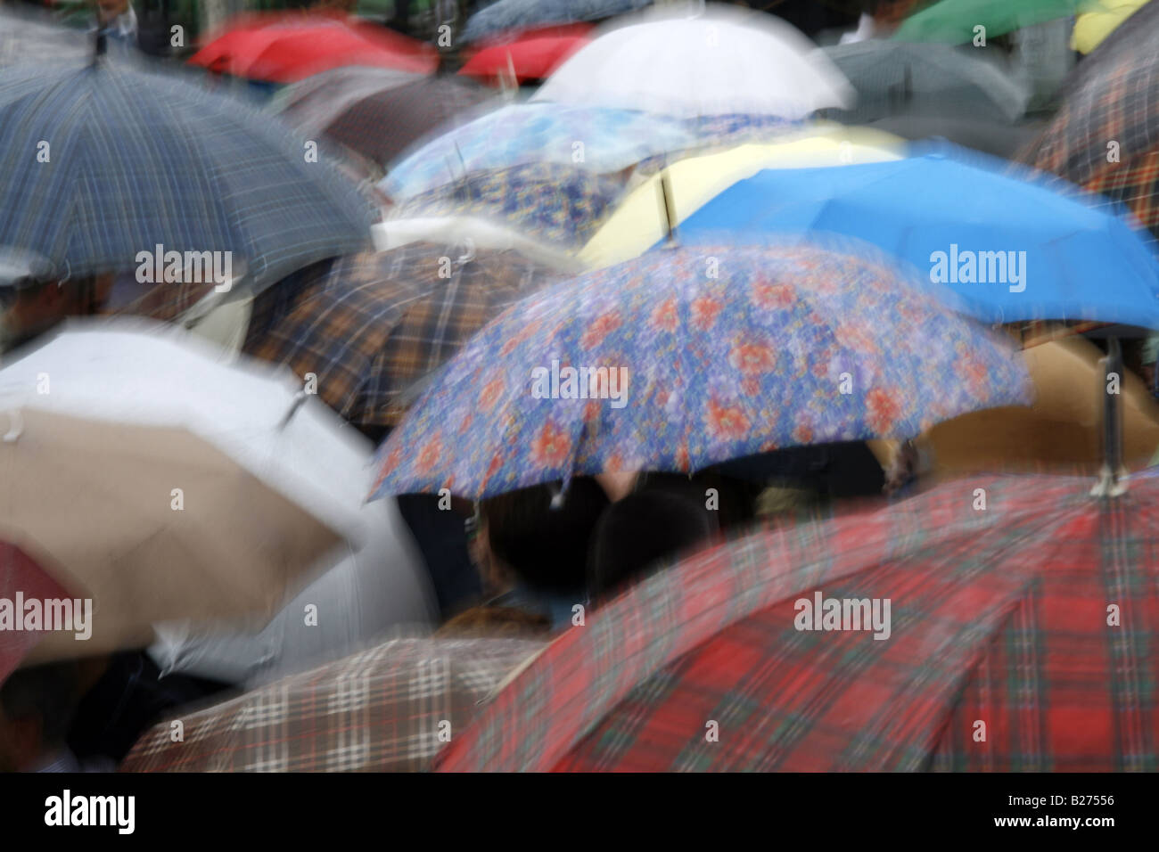 crowd of people with umbrellas in rain in town Stock Photo - Alamy