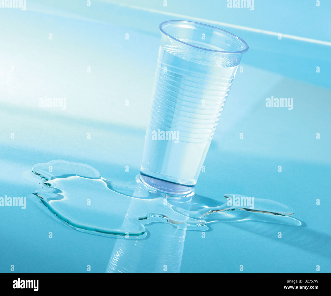 Drinking water in a plastic cup spilled on a blue background Stock ...