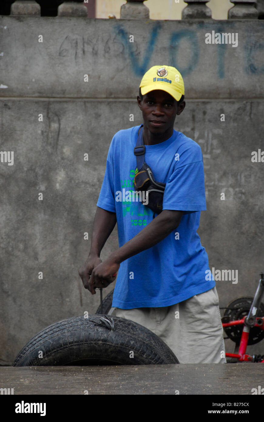 Local Haitian man inflating a tire, Jacmel, Haiti Stock Photo - Alamy