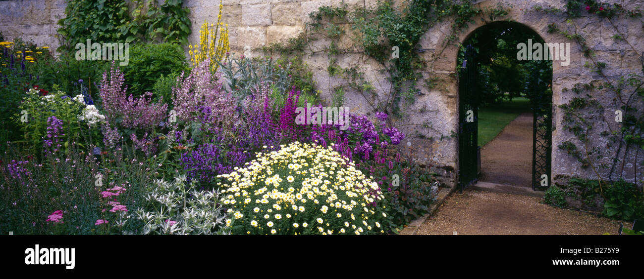 A gateway and flowers in bloom in The University of Oxford Botanic ...