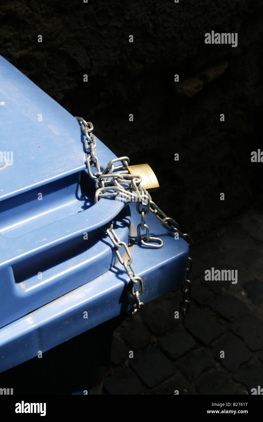 household rubbish bin locked with chain and padlock Stock Photo - Alamy