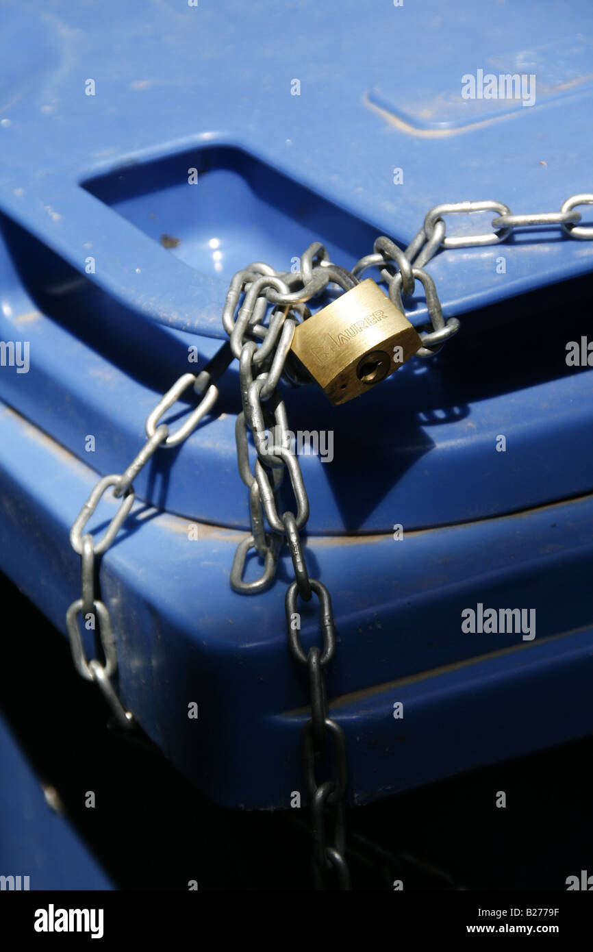 household rubbish bin locked with chain and padlock Stock Photo - Alamy