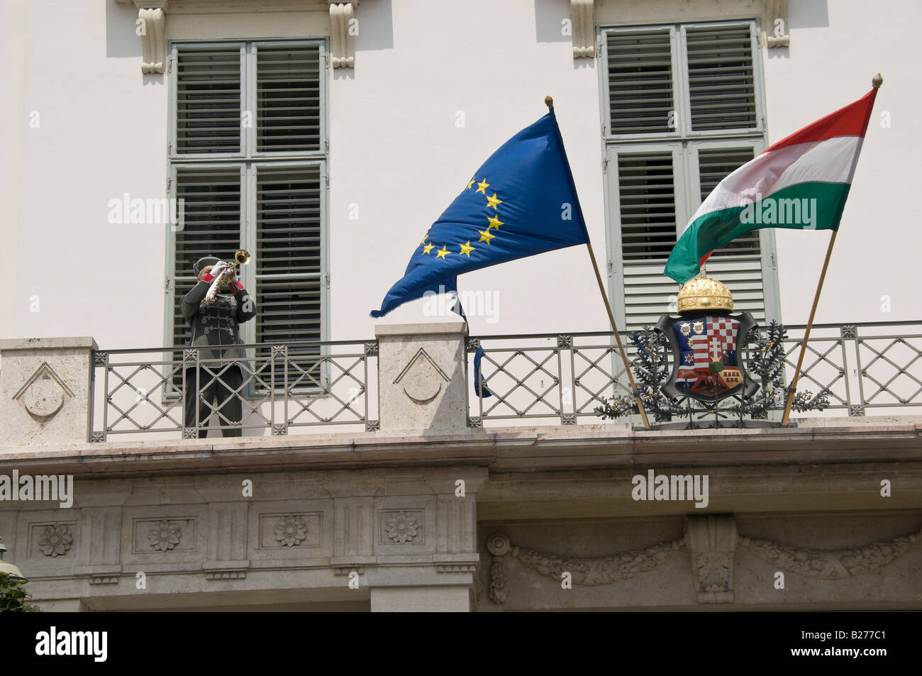 Hungarian Soldier in Ceremonial uniform sounds a trumpet on a balcony ...