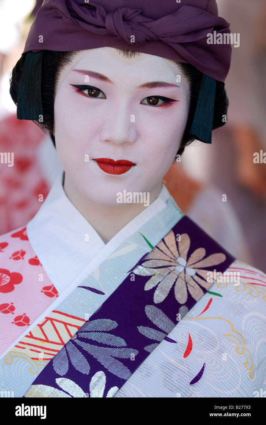 Close-up portrait of beautiful apprentice geisha or maiko wearing ...