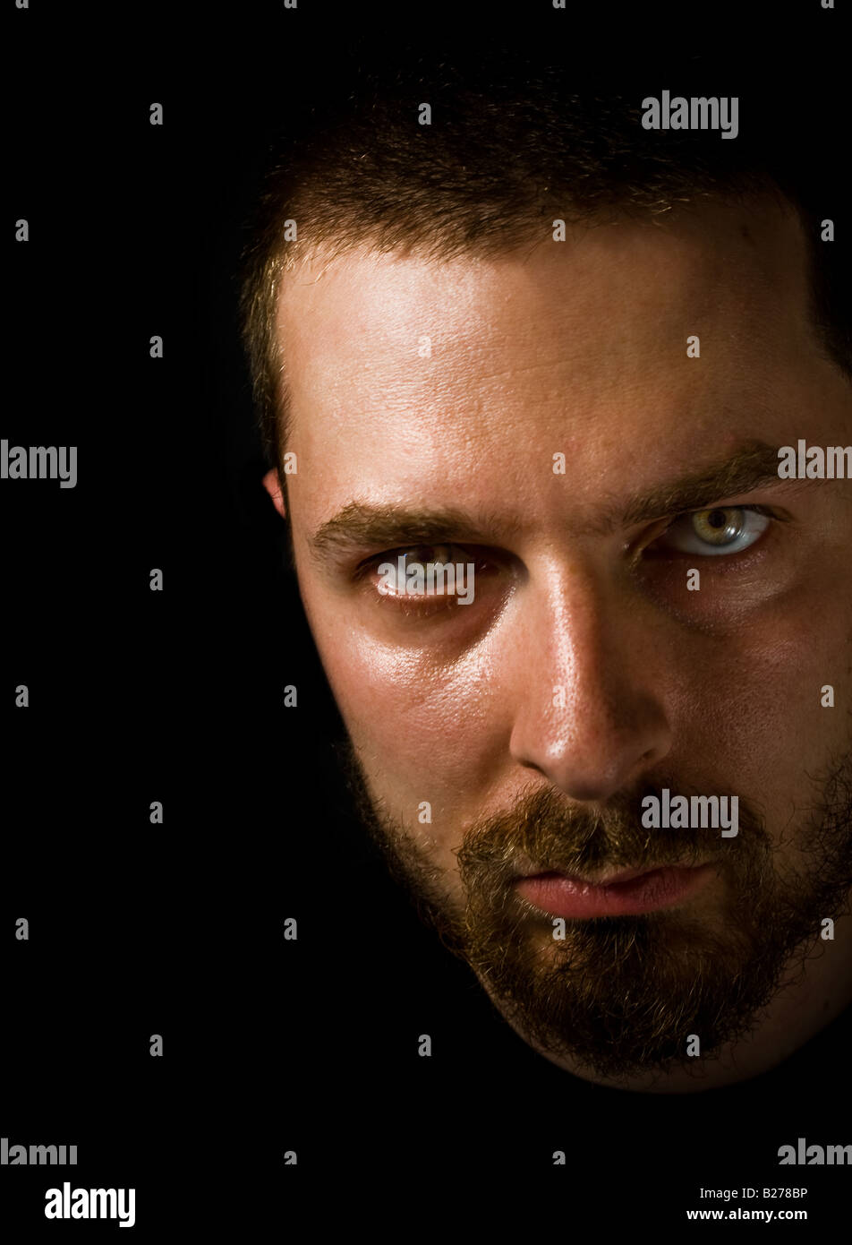 Low key portrait of sinister man with scary eyes Stock Photo - Alamy