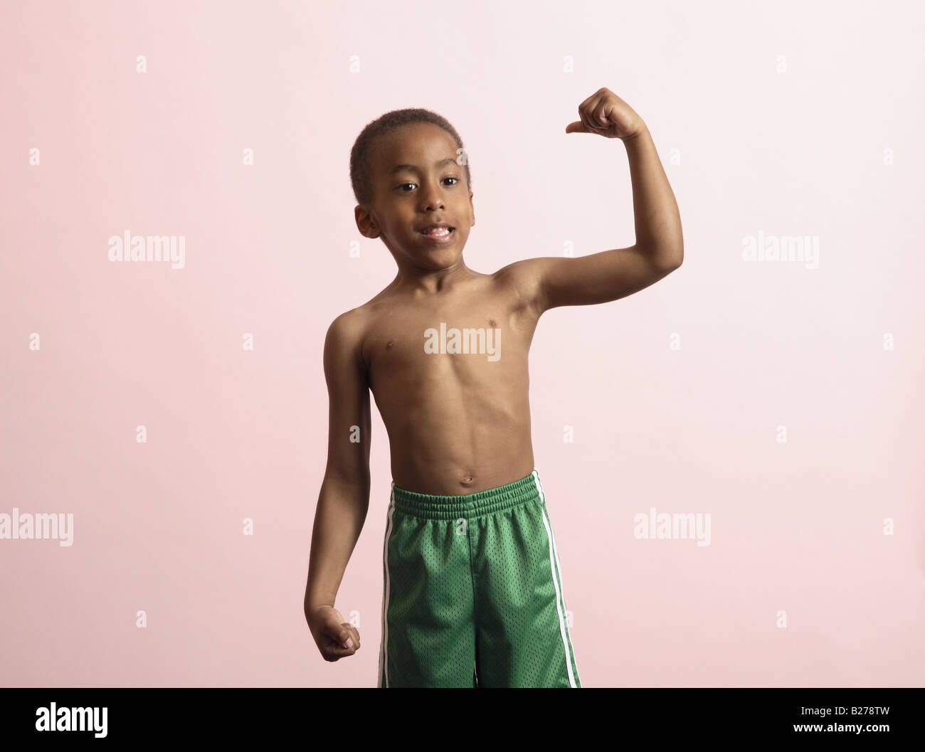 young boy flexing muscle Stock Photo - Alamy