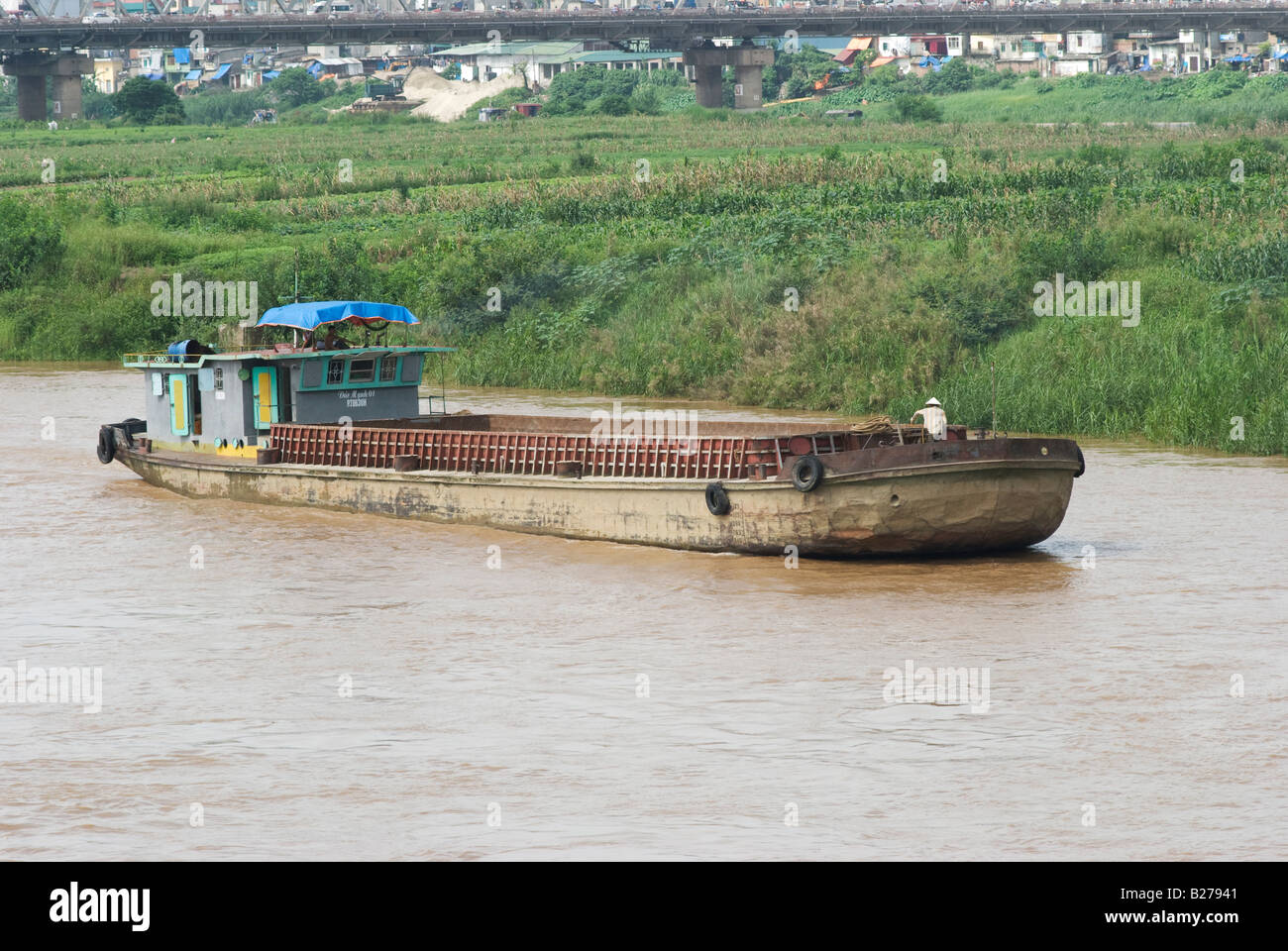 Empty small cargo vessel on its way up th Red River at Hanoi Stock ...