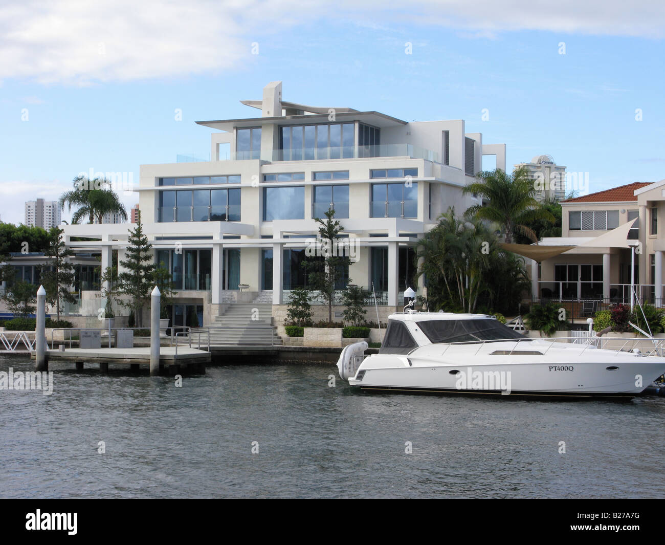 Luxury waterfront house with yacht moored in front Stock Photo - Alamy