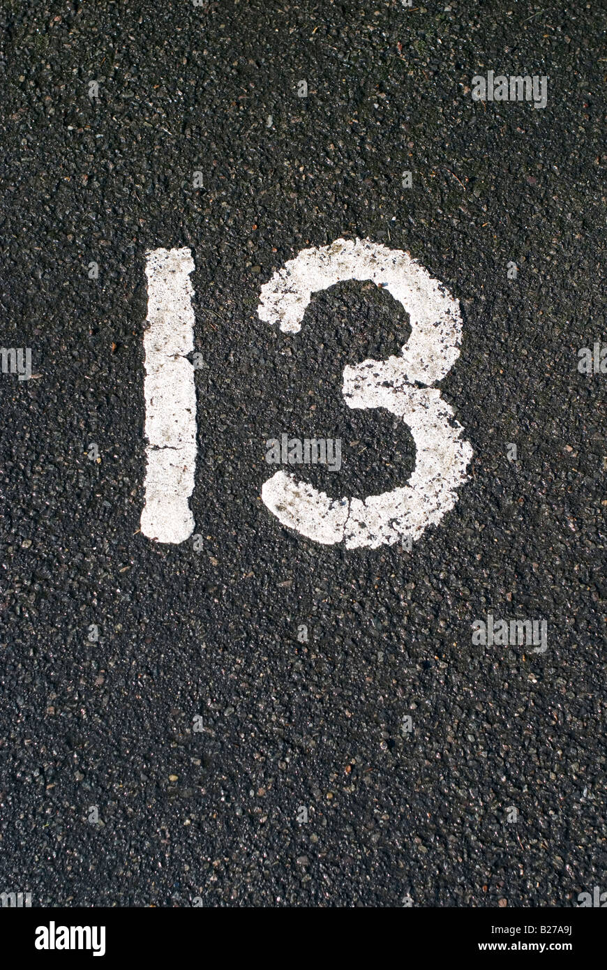 White painted number Thirteen on Tarmac Stock Photo - Alamy