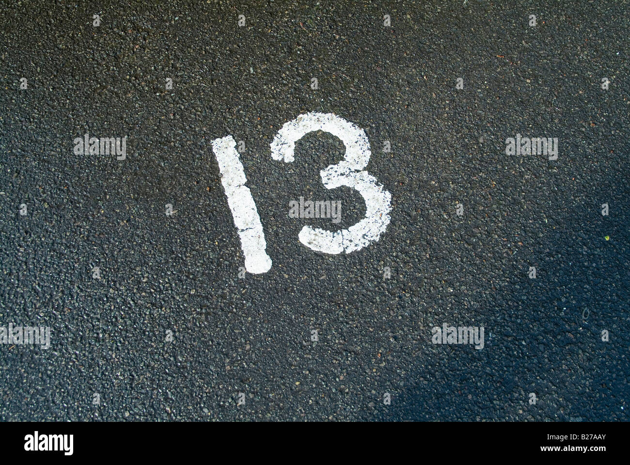 White painted number Thirteen on Tarmac Stock Photo - Alamy