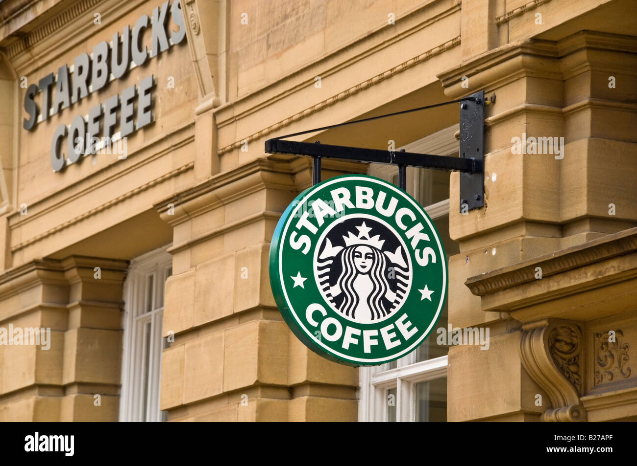 Modern Starbucks Coffee sign outside an old Victorian building in York ...
