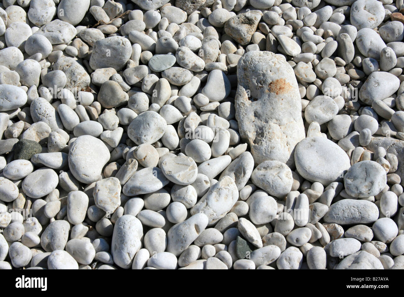 Small grey pebbles on the beach Stock Photo - Alamy