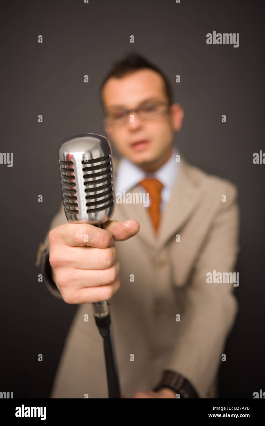 Elegant young singer whit old microphone Stock Photo - Alamy
