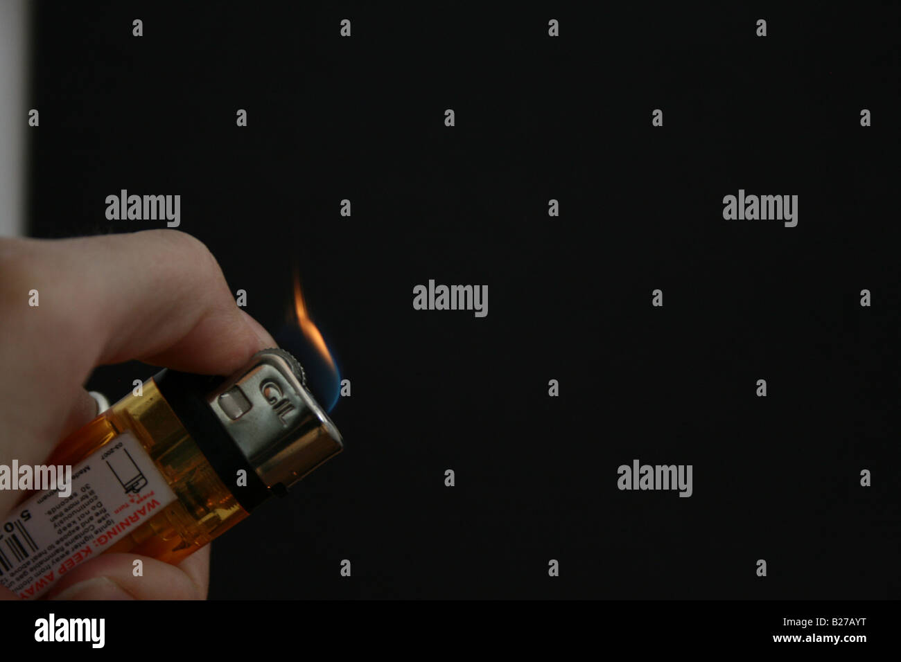 Someone using a lighter Stock Photo - Alamy