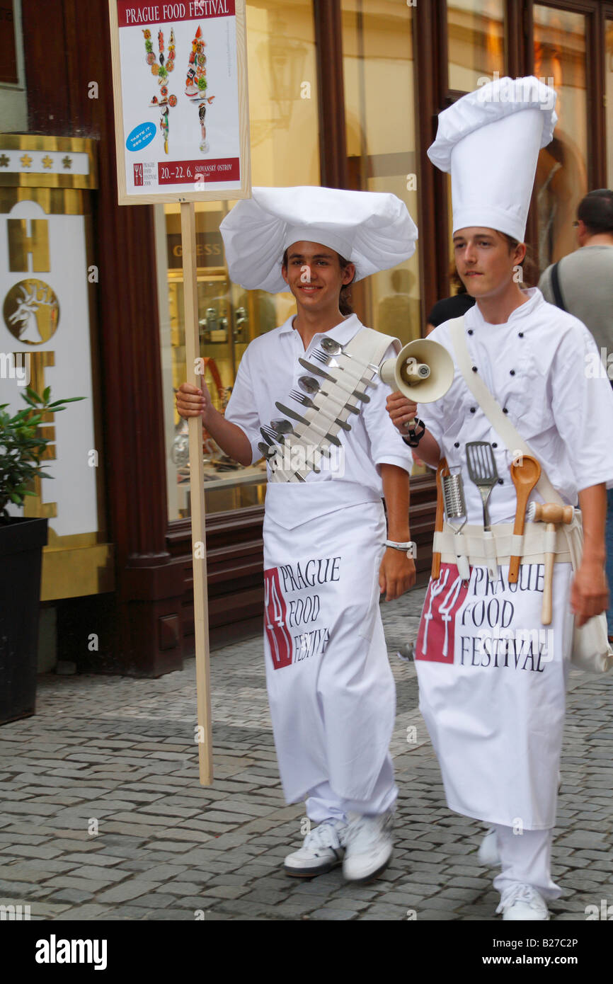 Two young chefs walking along Karlova street in Prague inviting ...