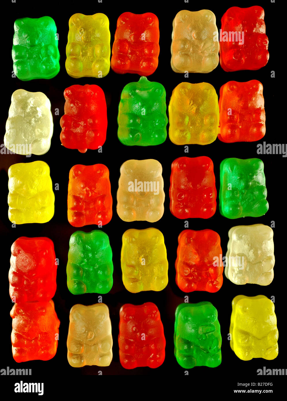Candy bears illuminated and isolated on black background Stock Photo ...