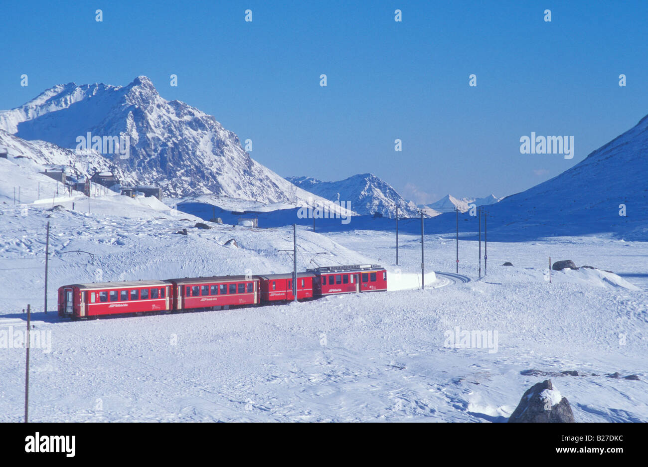 Raethische Bahn train at the Bernina pass in winter Grisons Switzerland ...
