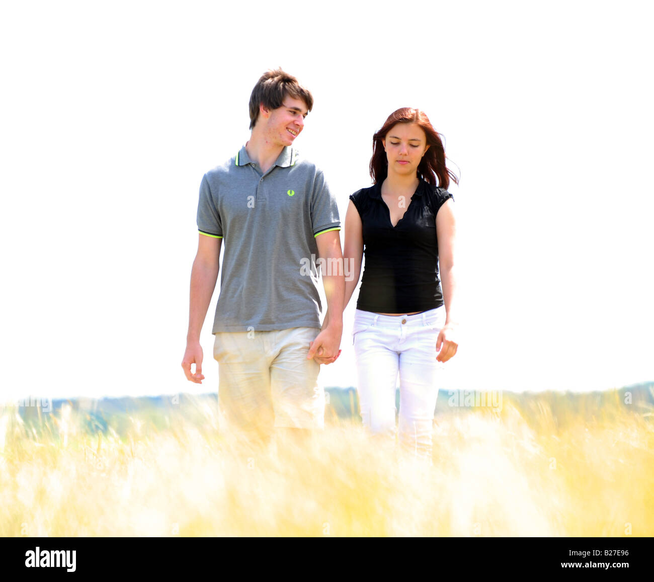 two teenagers running in a field Stock Photo - Alamy