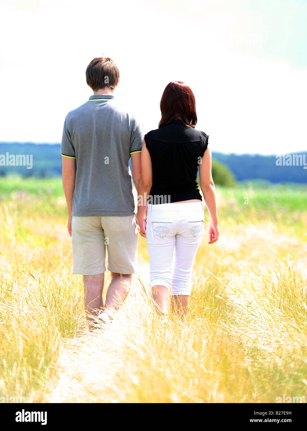 two teenagers running in a field Stock Photo - Alamy