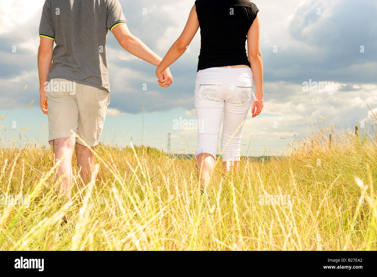 two teenagers running in a field Stock Photo - Alamy