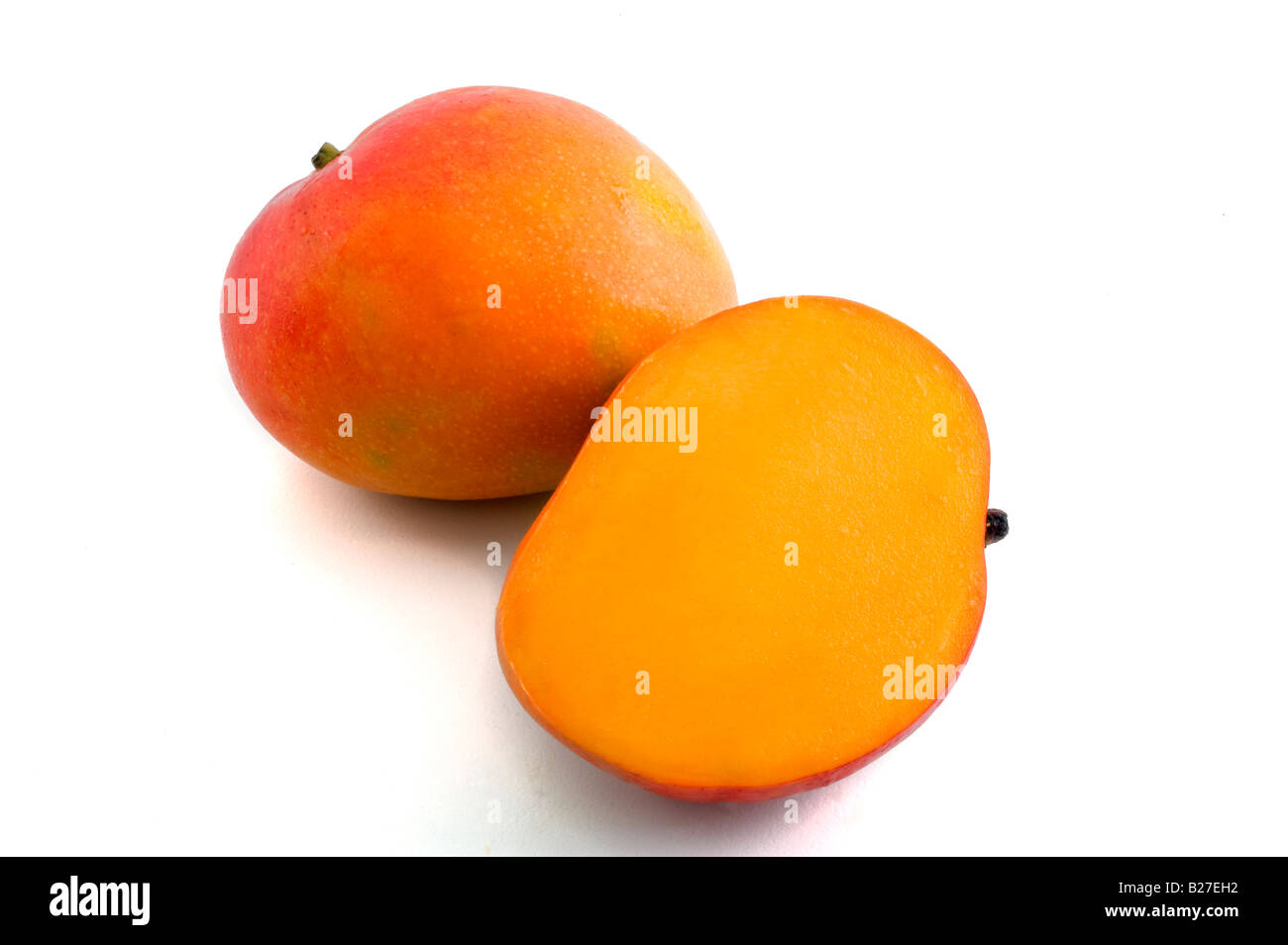 Maya mango whole and section isolated on white Stock Photo - Alamy