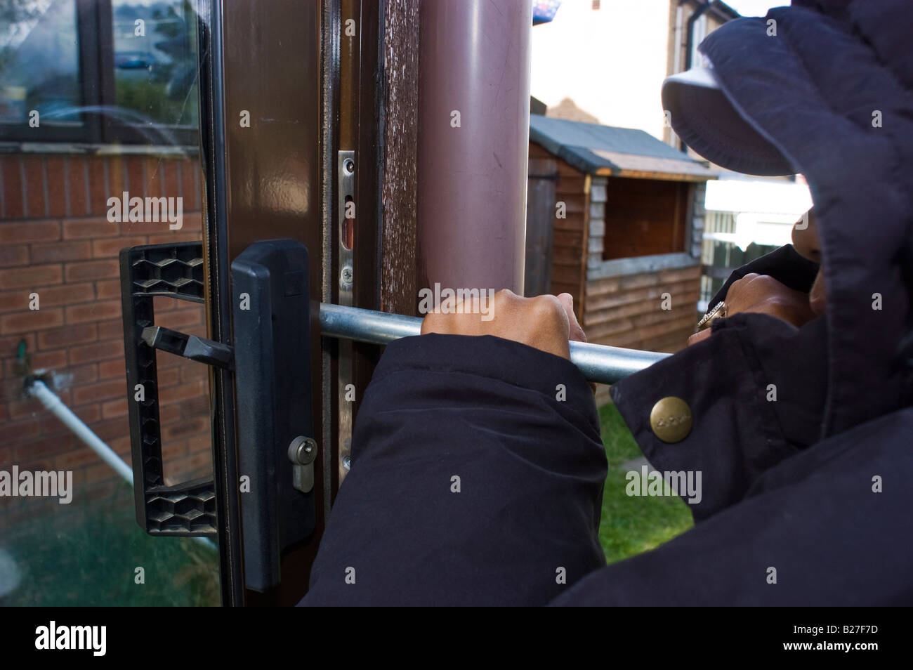 Burglar breaking into a house though a window Stock Photo - Alamy