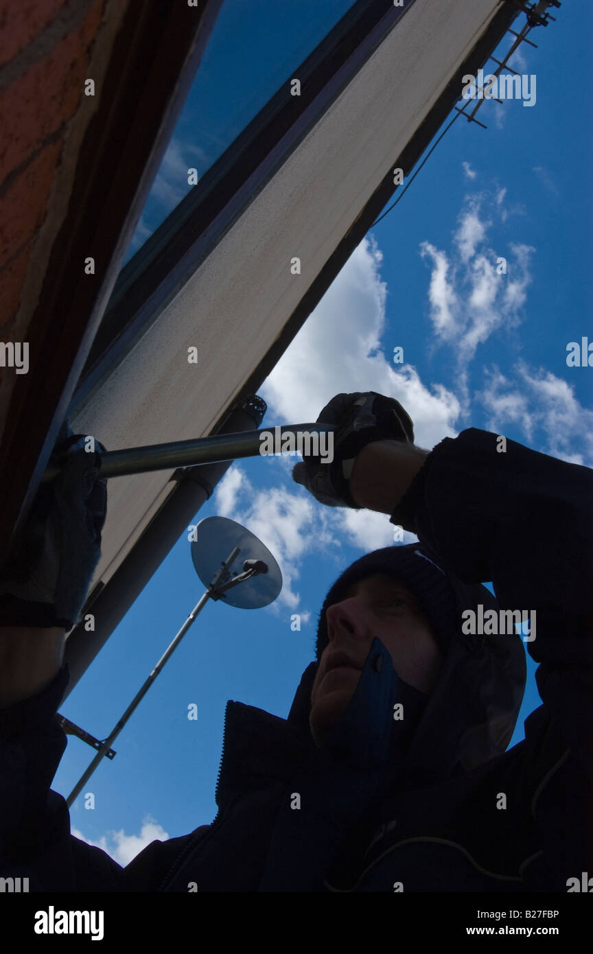 Burglar breaking into a house though a window Stock Photo - Alamy