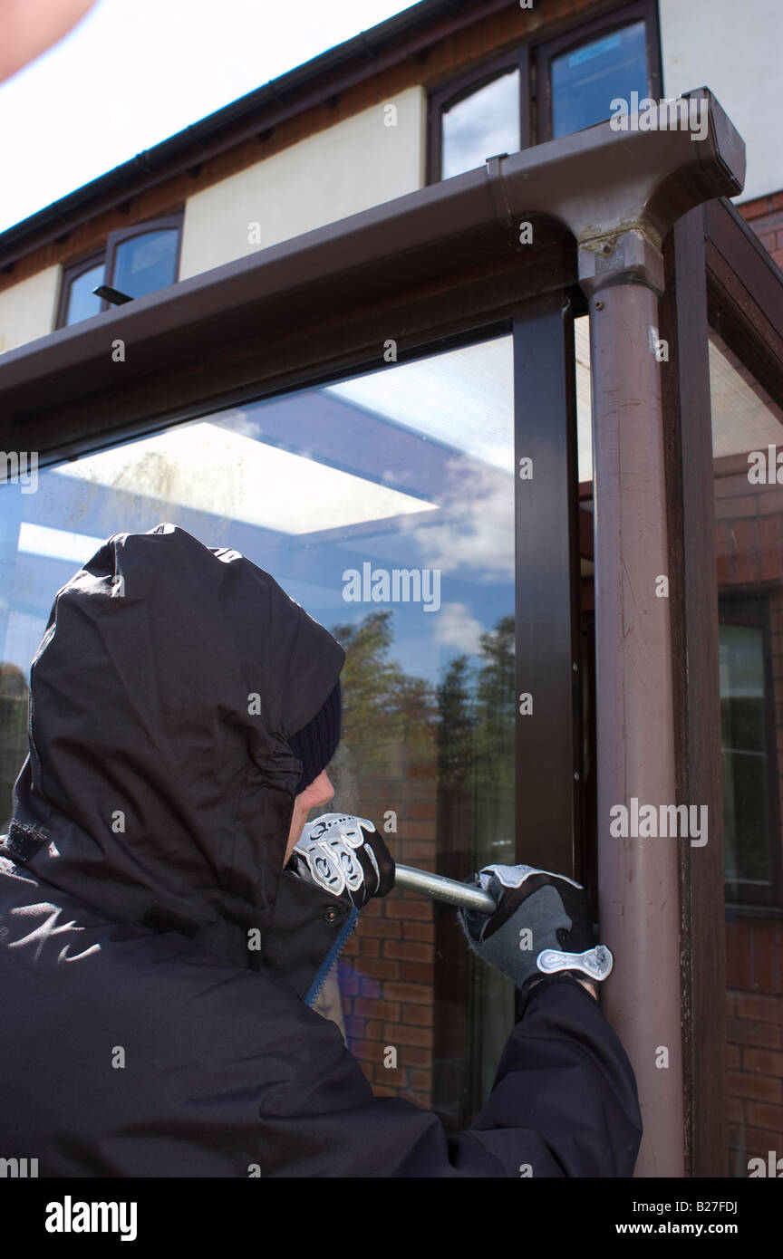 Burglar breaking into a house though a window Stock Photo - Alamy