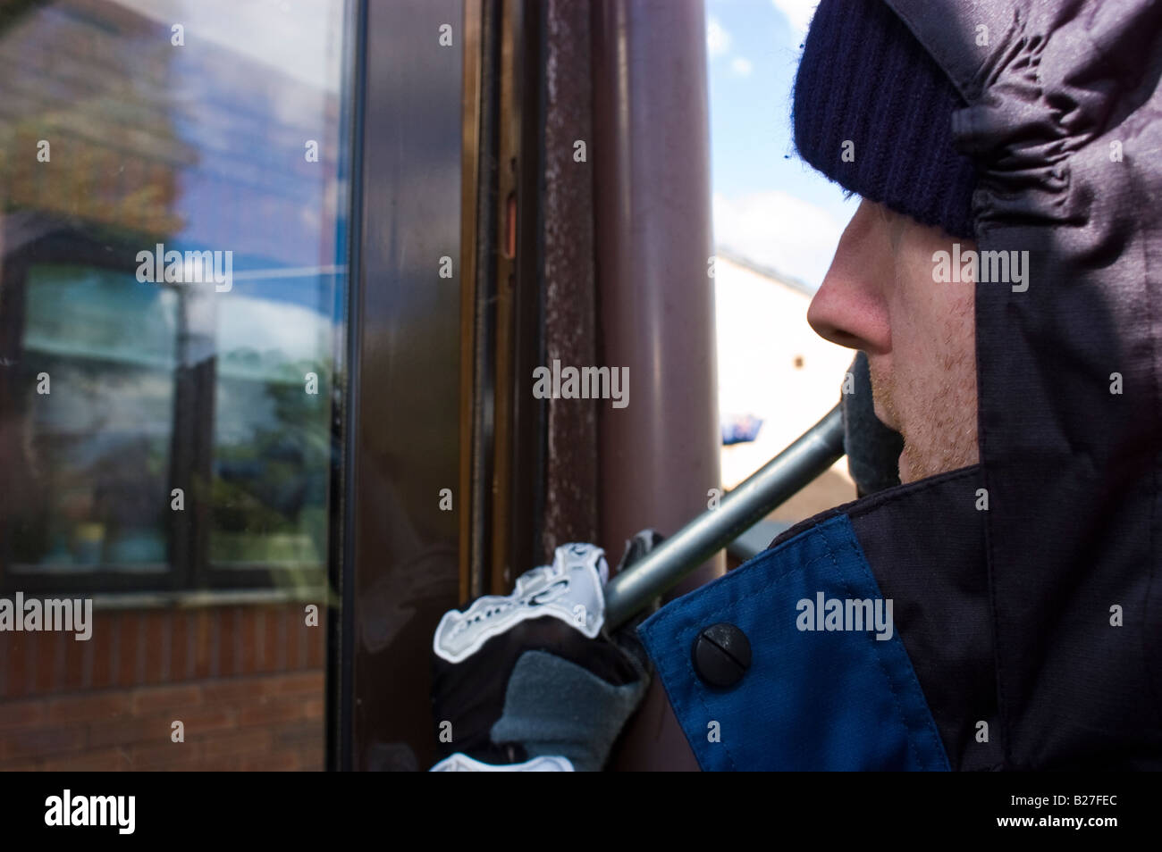 Burglar breaking into a house though a window Stock Photo - Alamy