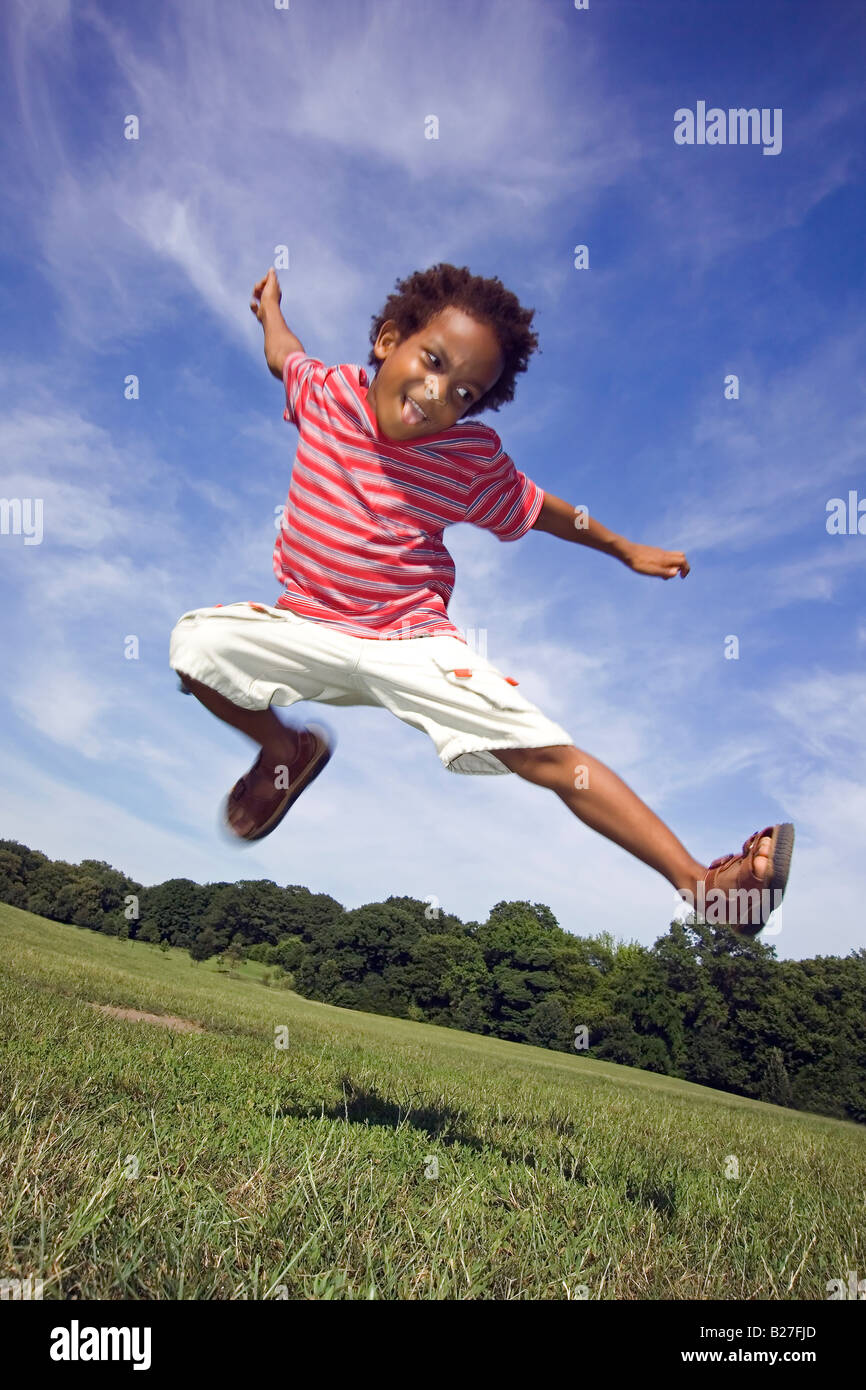 Boy jumping vertical Stock Photo - Alamy