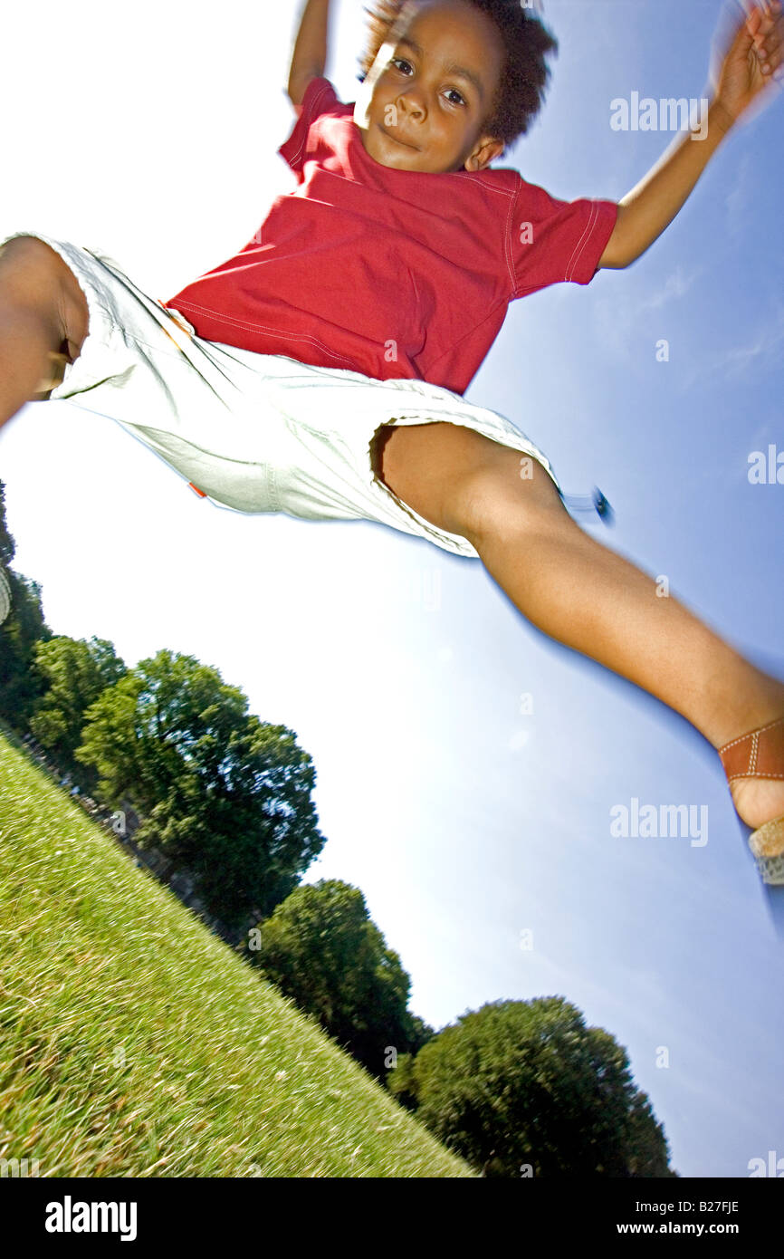 Boy jumping vertical Stock Photo - Alamy