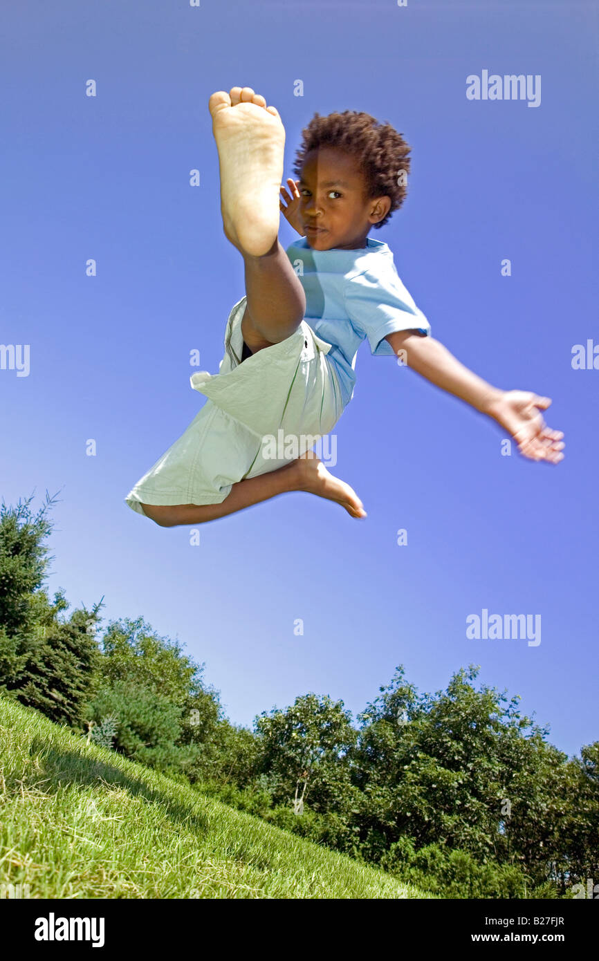Boy jumping vertical Stock Photo - Alamy