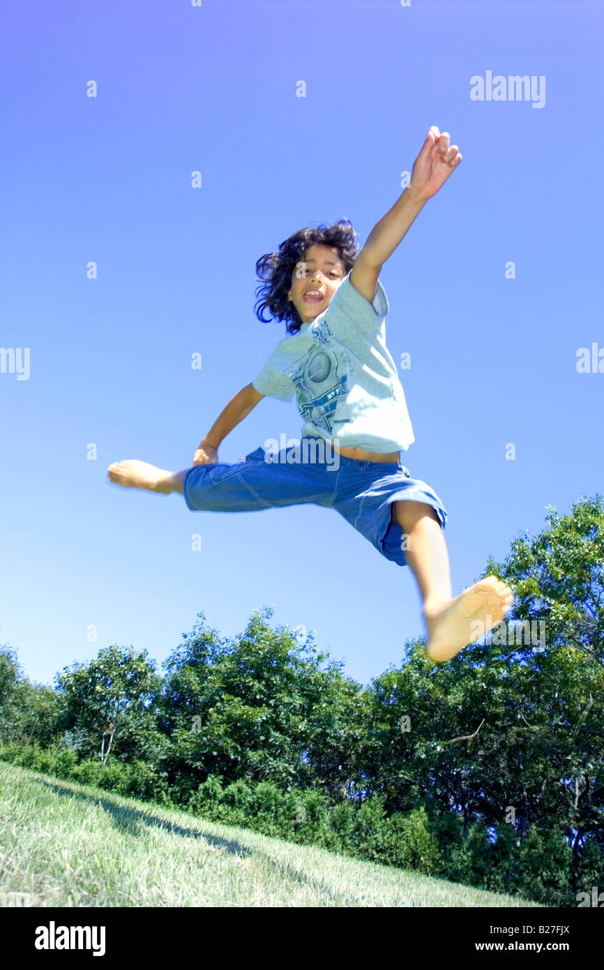 Boy jumping vertical Stock Photo - Alamy