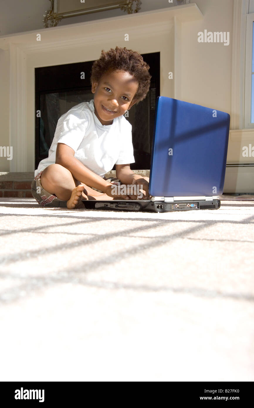 Boy with computer vertical Stock Photo - Alamy
