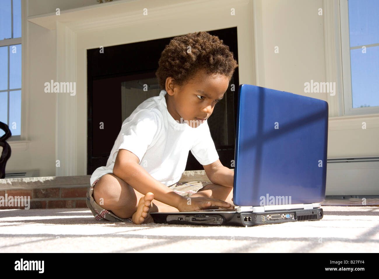 Boy with computer horizontal Stock Photo - Alamy