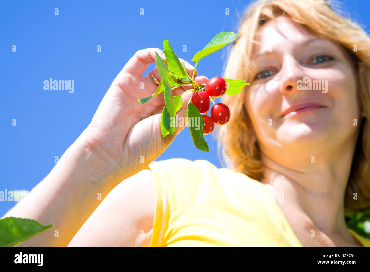 Woman with cherries Stock Photo - Alamy