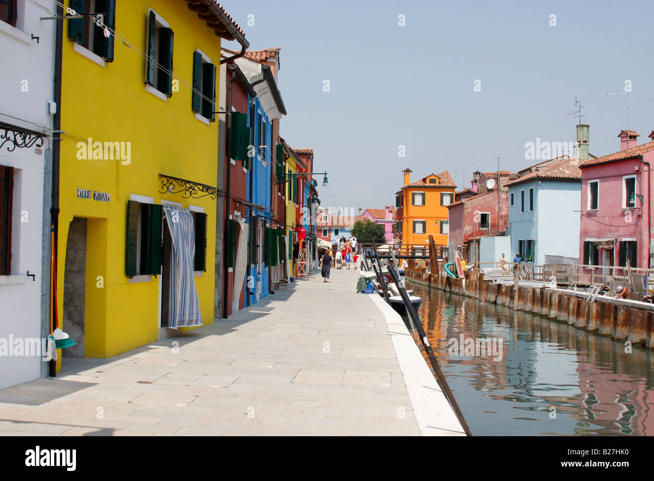 Row of brightly painted houses and boats along a canal in Burano ... Row of brightly painted houses and boats along a canal in Burano ...