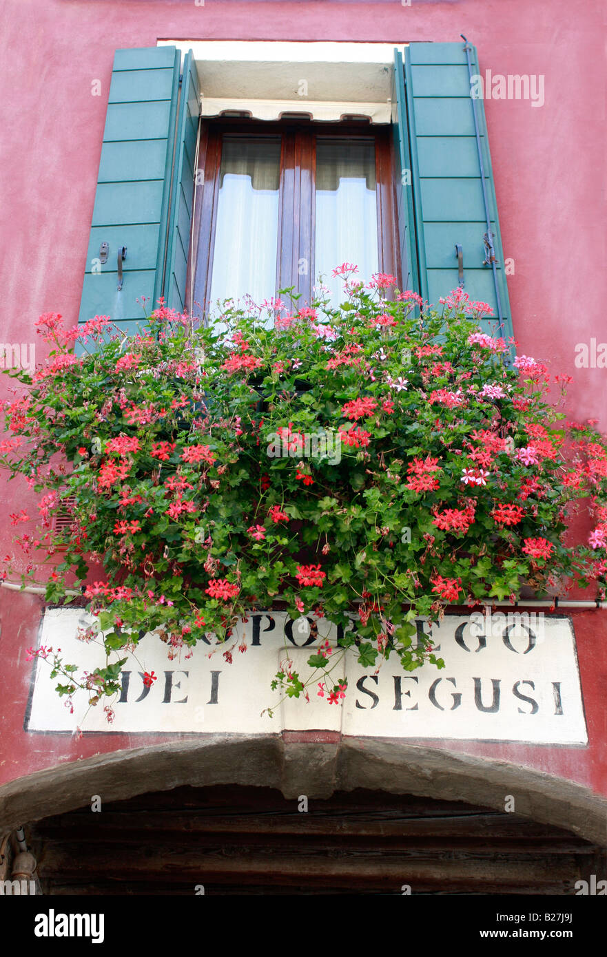 romantic shuttered window on typical painted houses lining the streets ...