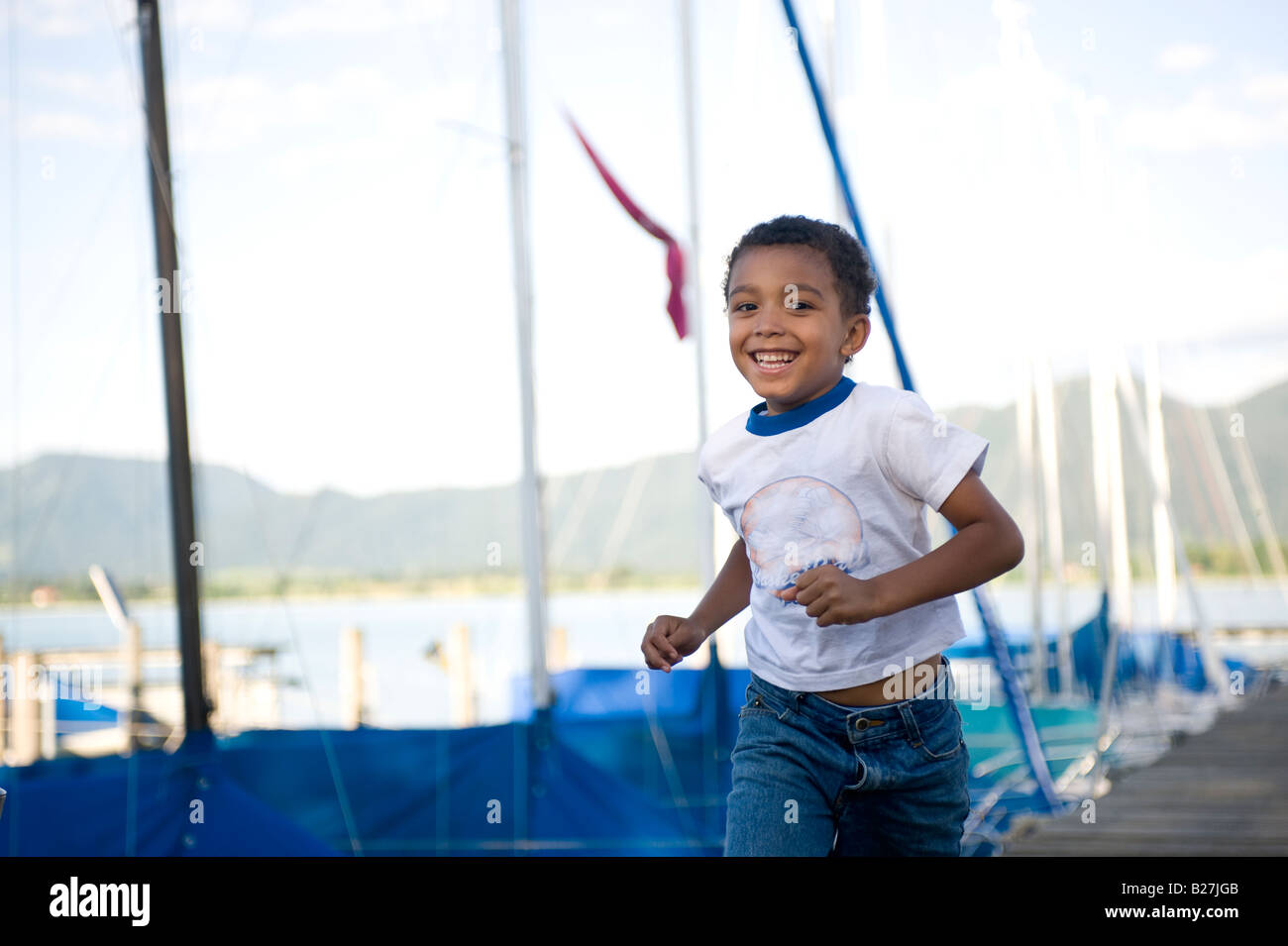 Boy on pier by boat hi-res stock photography and images - Alamy