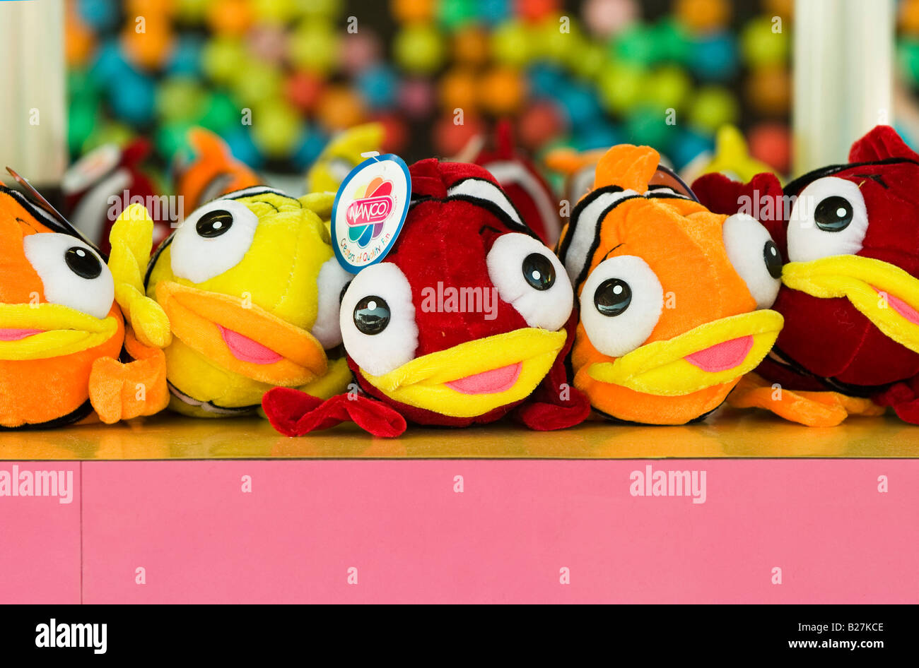 fluffy and colorful toy fish as prizes at a stall at a carnival in ...